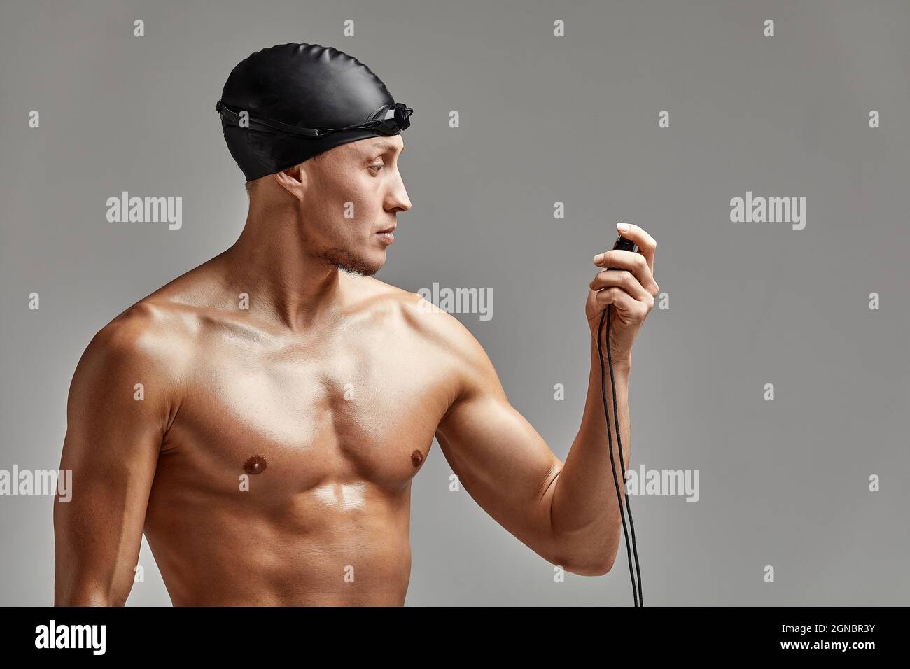 A coach with a stopwatch in his hands, a sports swimming coach with a ...