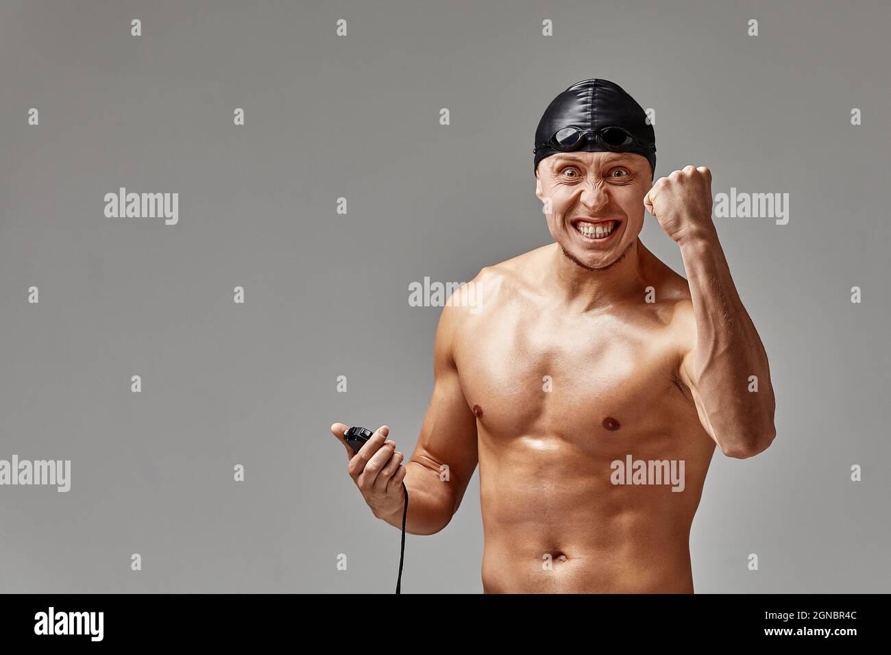 A coach with a stopwatch in his hands, a sports swimming coach with a ...