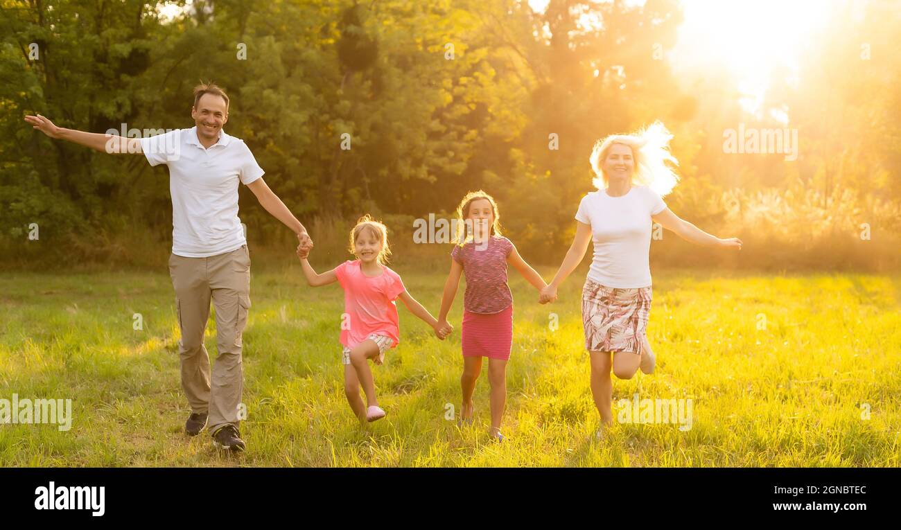 Happy family enjoying life together at meadow outdoor Stock Photo - Alamy