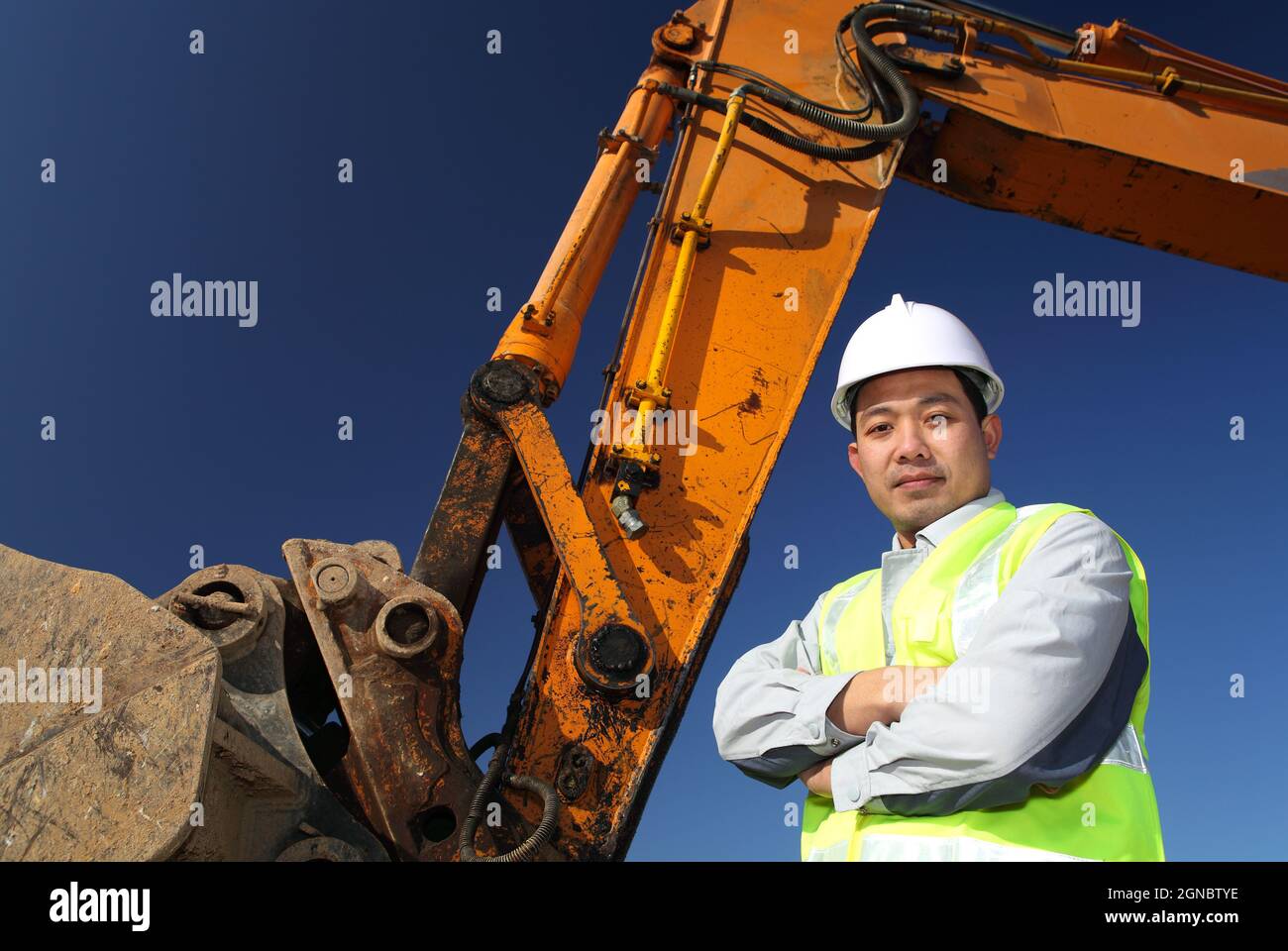 portrait operator of excavator standing on location site Stock Photo ...