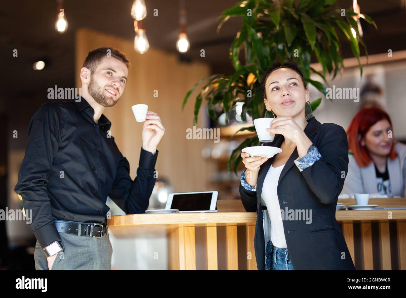 Friends at a cafe having coffee and chatting. Successful young people ...
