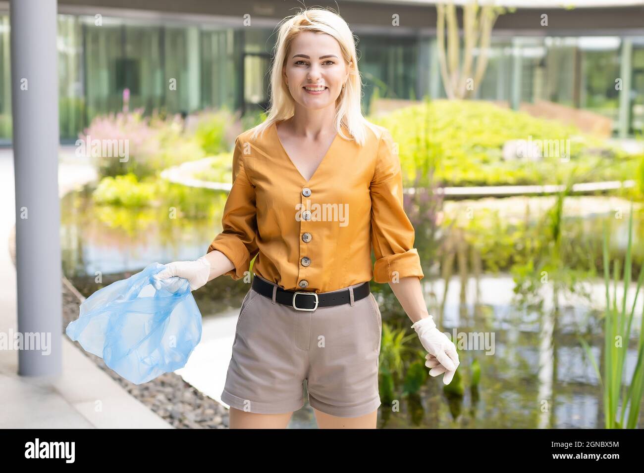 woman picking up trash outdoors in the street in summer Stock Photo - Alamy