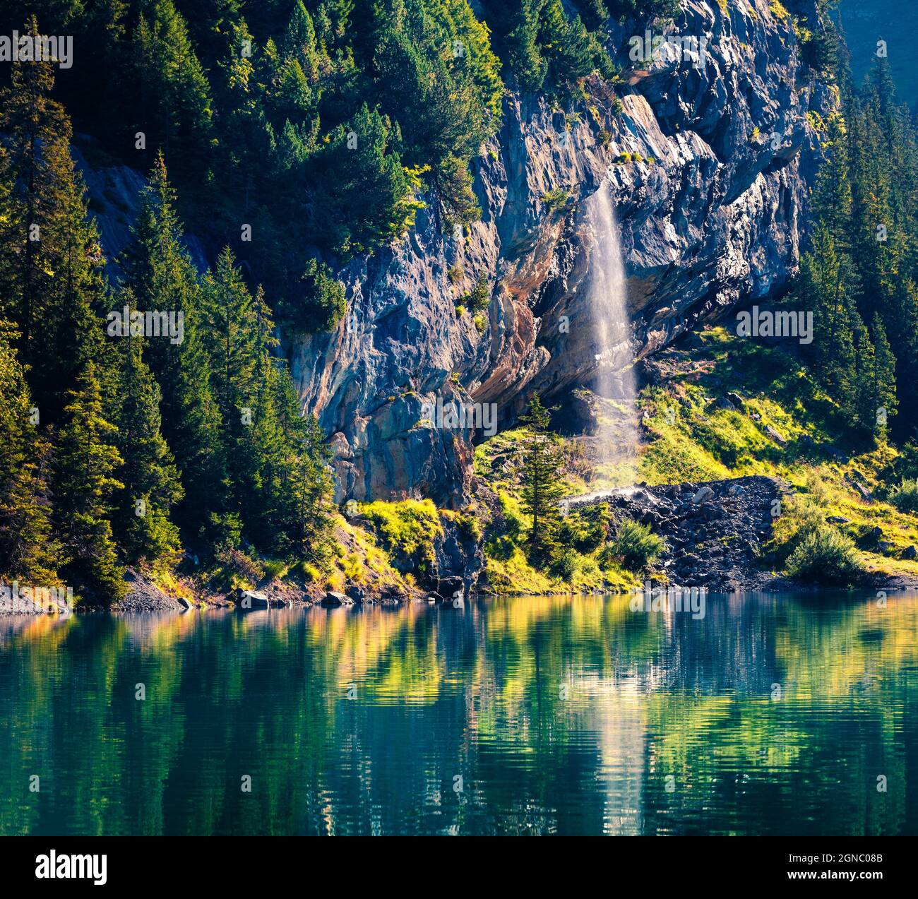 Sparkling waterfall on the Oeschinensee Lake. Splendid summer morning ...