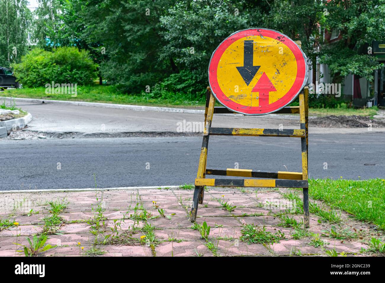 Road sign standing on the side of the road indicating that you must ...
