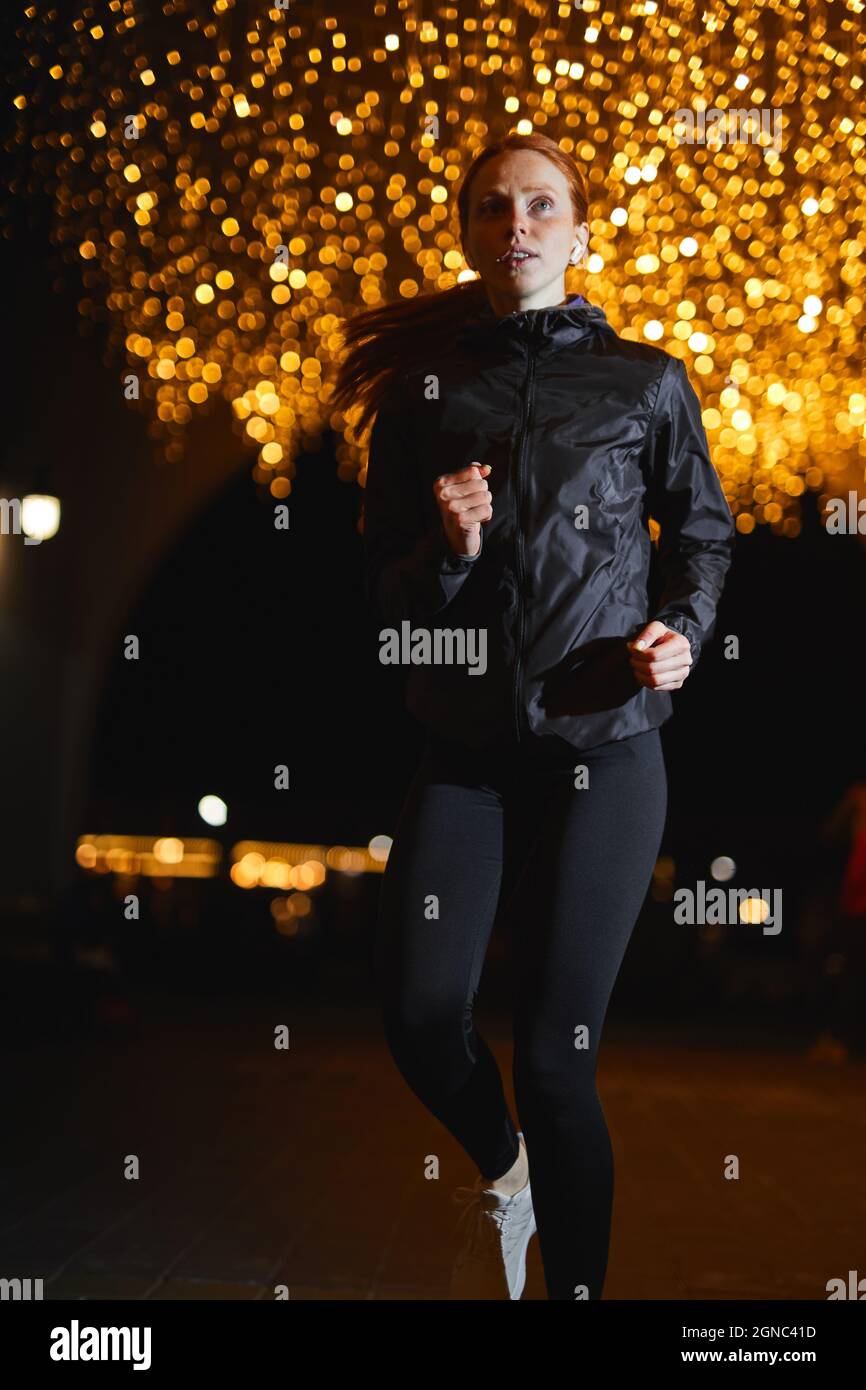 Sport woman running along night hi-res stock photography and images - Alamy
