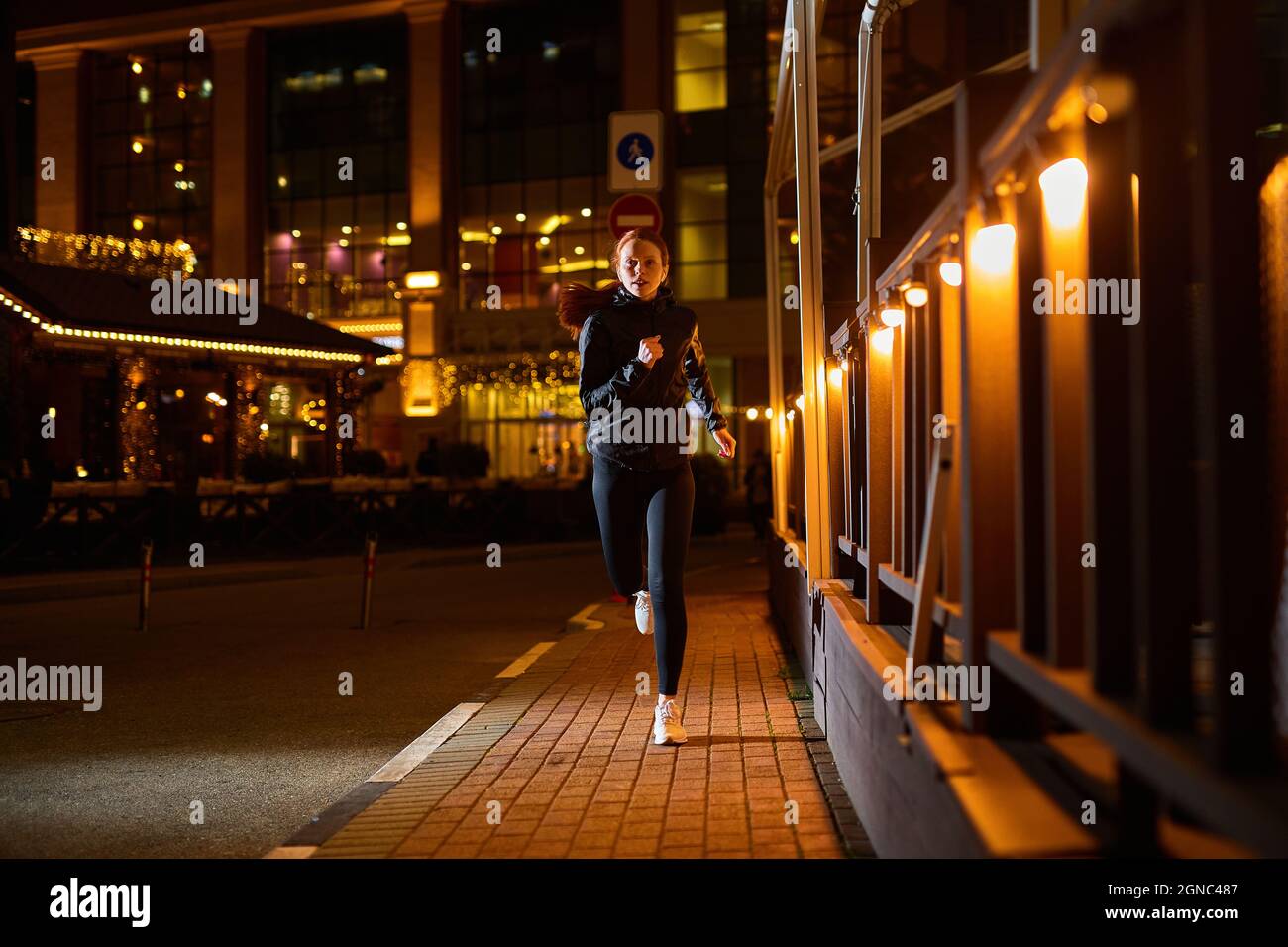 Woman trainer at night city hi-res stock photography and images - Alamy