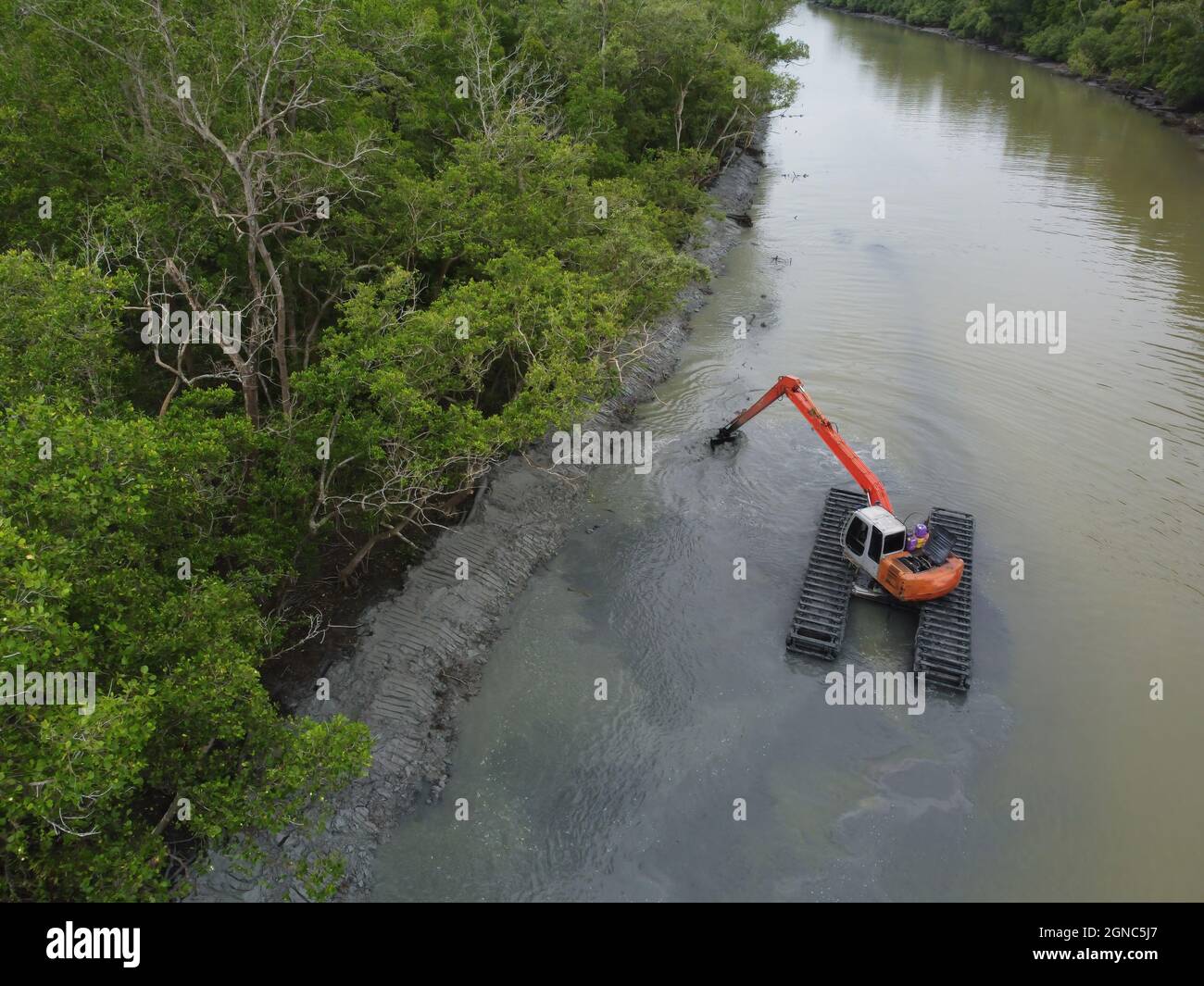Excavator working in river Stock Photo - Alamy