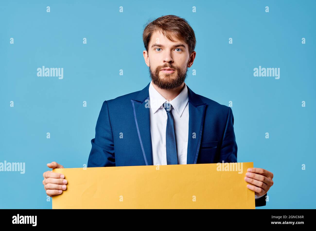 bearded man yellow mockup poster in hand blue background Stock Photo ...