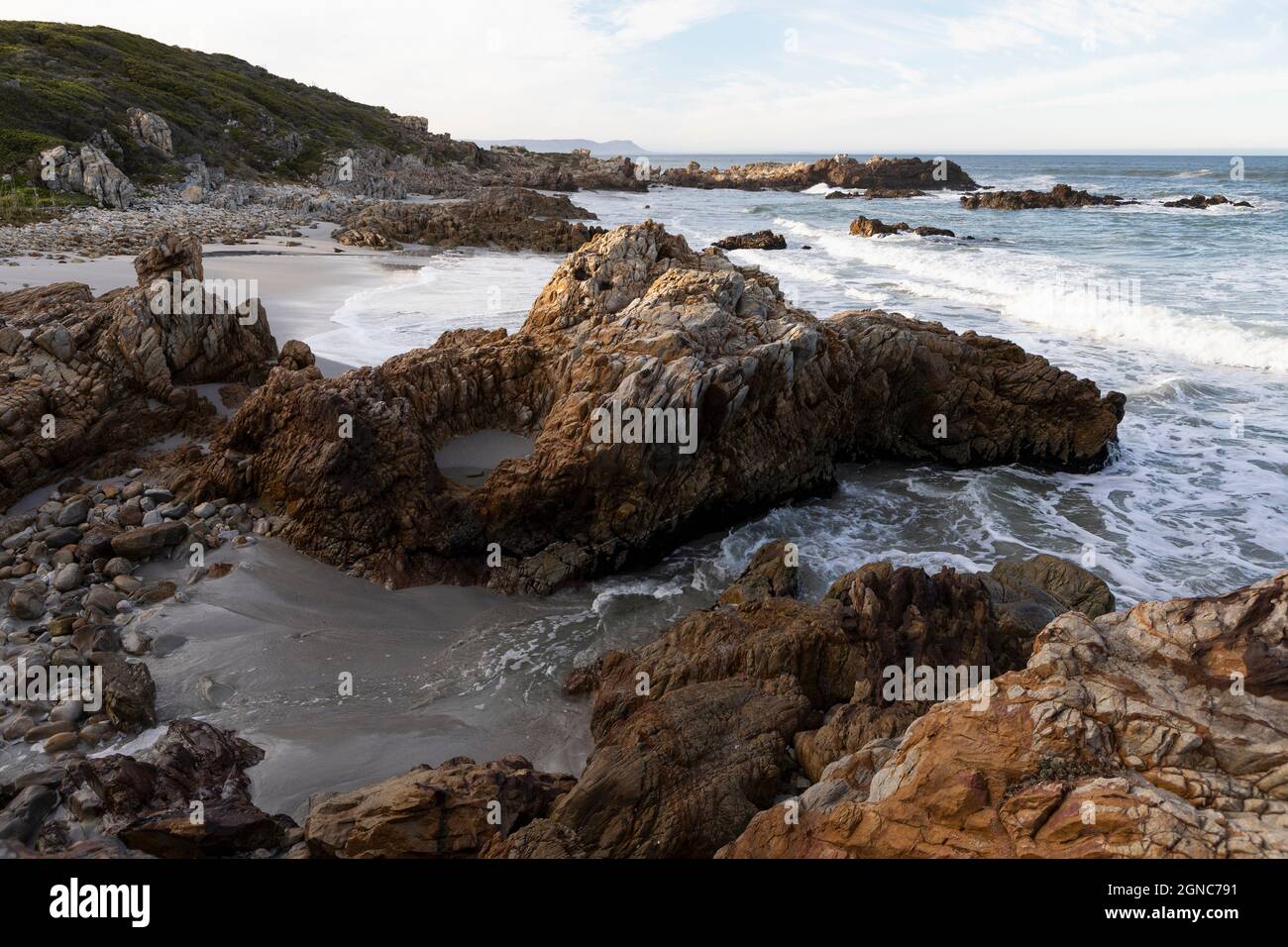 A deserted beach, jagged rocks and rockpools on the Atlantic coast ...