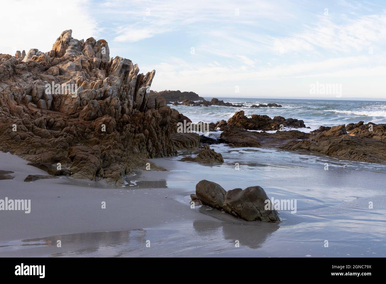 A deserted beach, jagged rocks and rockpools on the Atlantic coast ...
