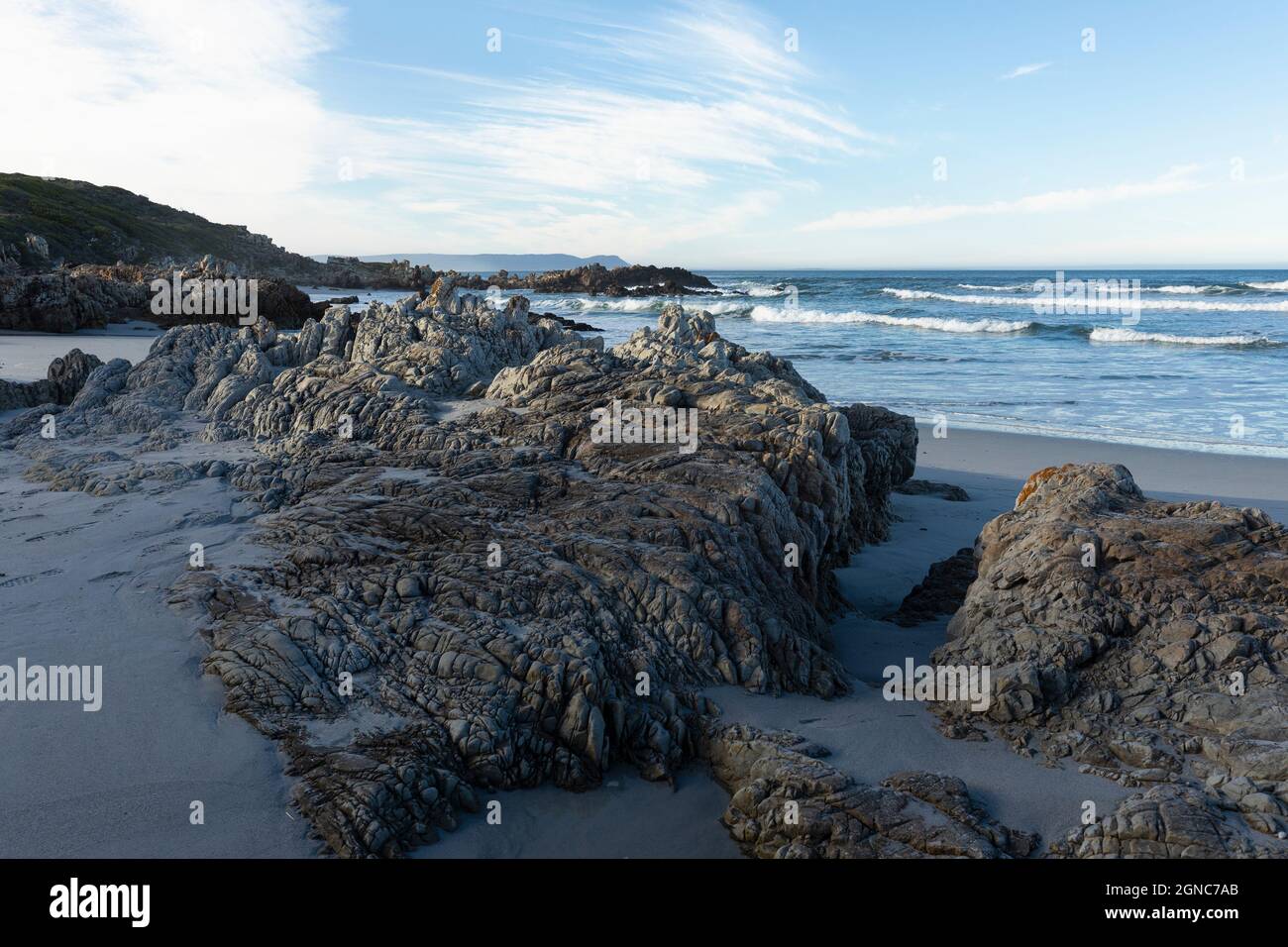 A deserted beach, jagged rocks and rockpools on the Atlantic coast ...