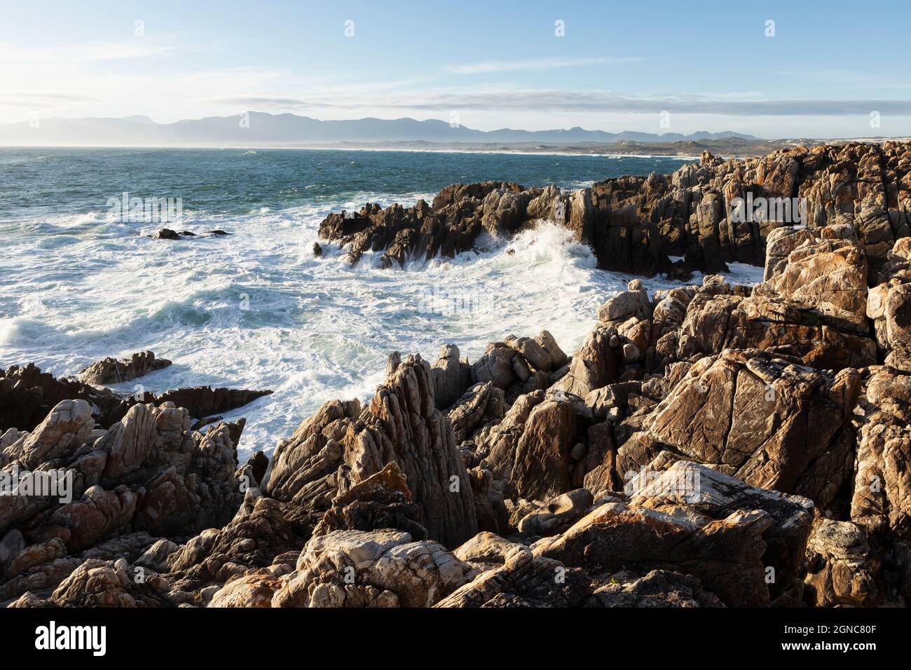 Jagged rocks on the Atlantic ocean coastline and white water waves ...