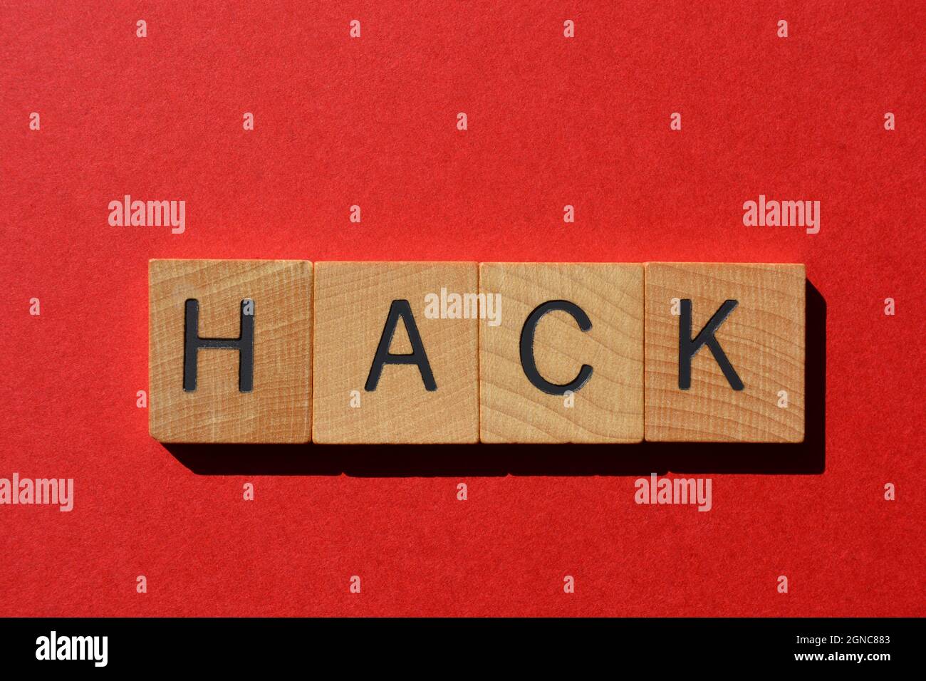 Hack, word in wooden alphabet letters isolated on red background as ...