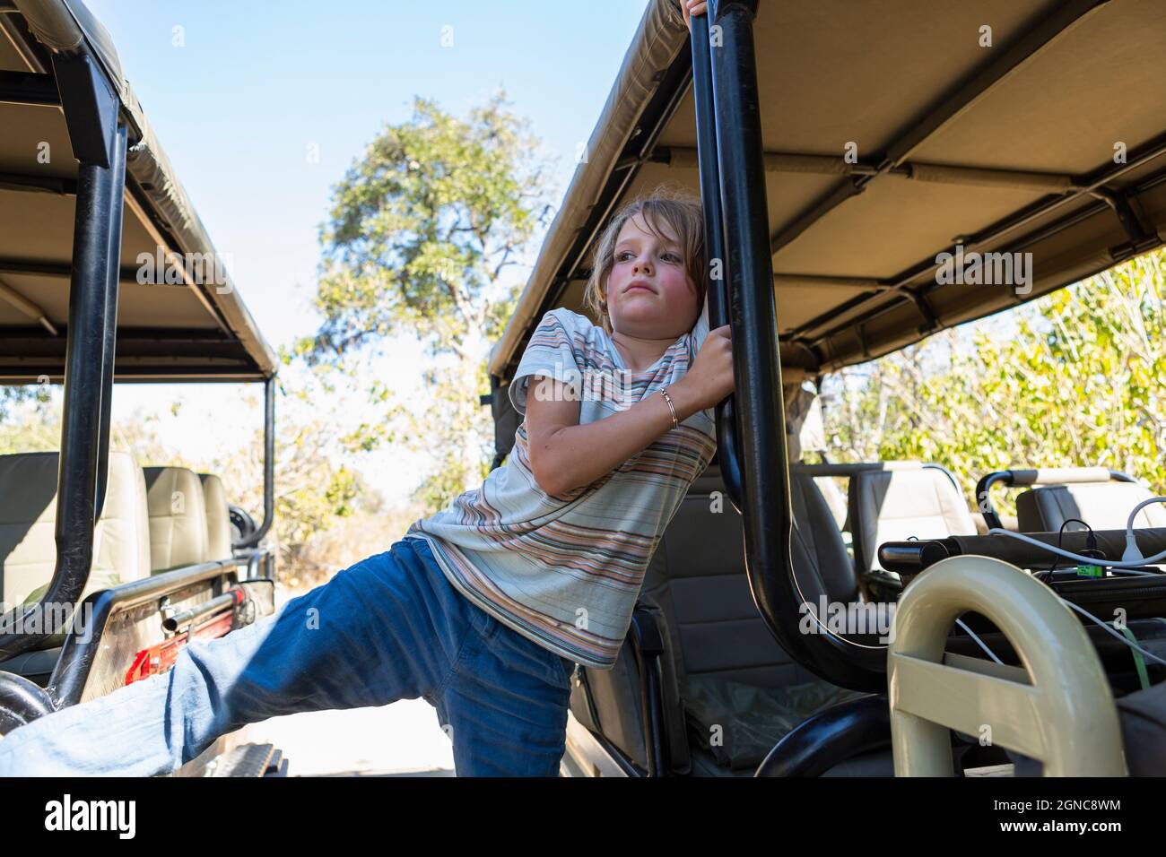 Young boy and safari vehicle, Okavango Delta, Botswana Stock Photo - Alamy