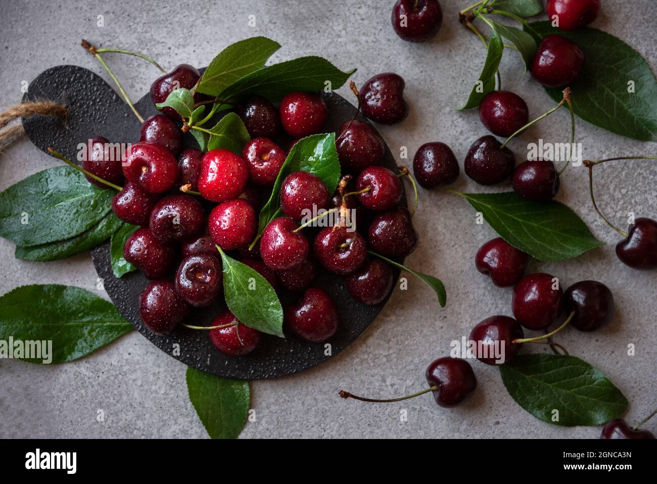 Fresh ripe cherry fruit with leaves on dark background Stock Photo - Alamy