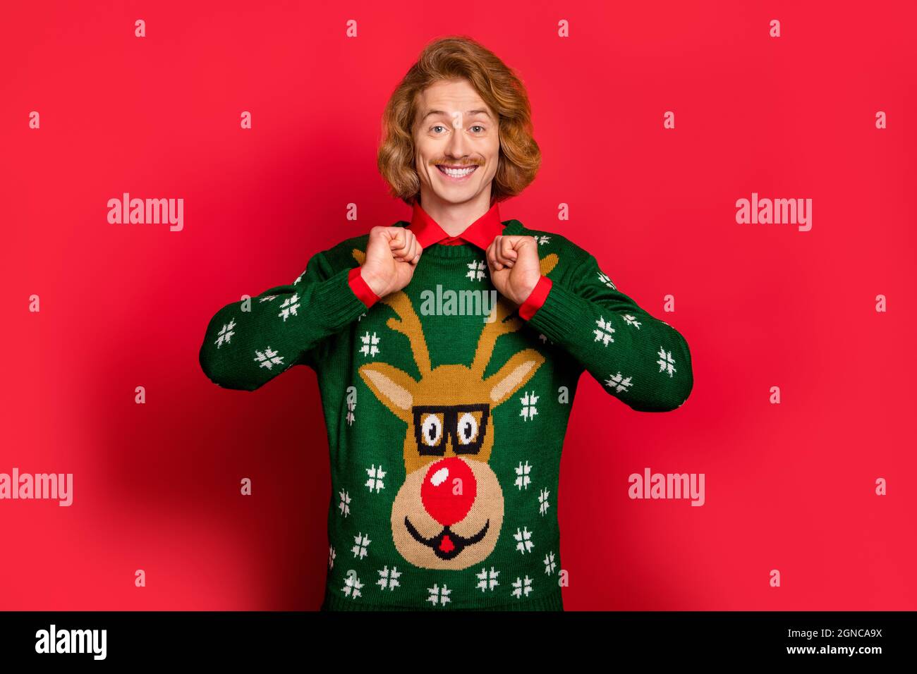 Portrait of attractive cheerful guy fixing collar shirt wearing deer ...