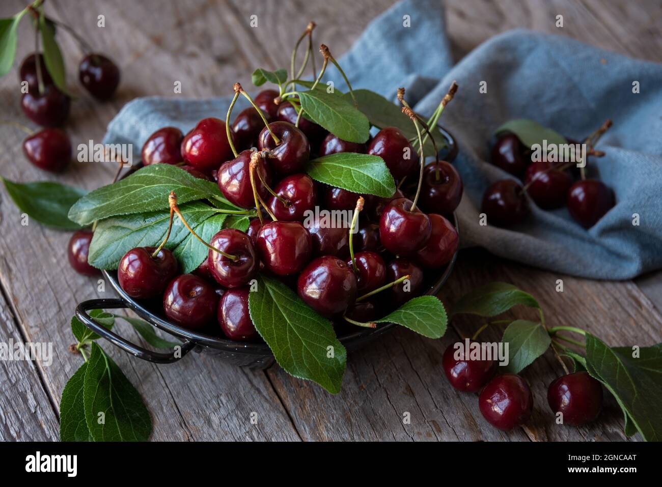 Fresh ripe cherry fruit with leaves on dark wood Stock Photo - Alamy