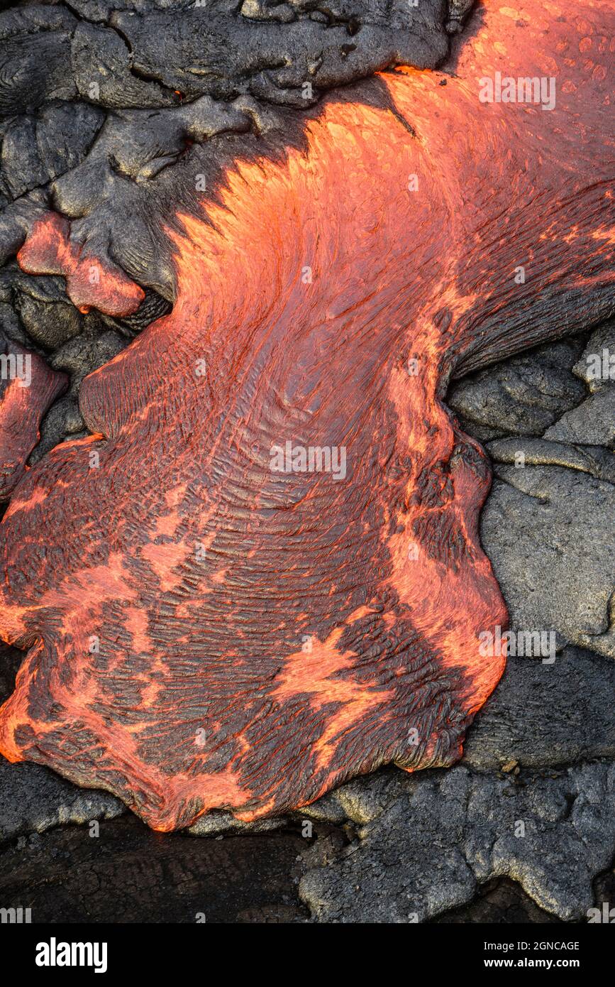 Lava flow over volcanic black rock Stock Photo - Alamy