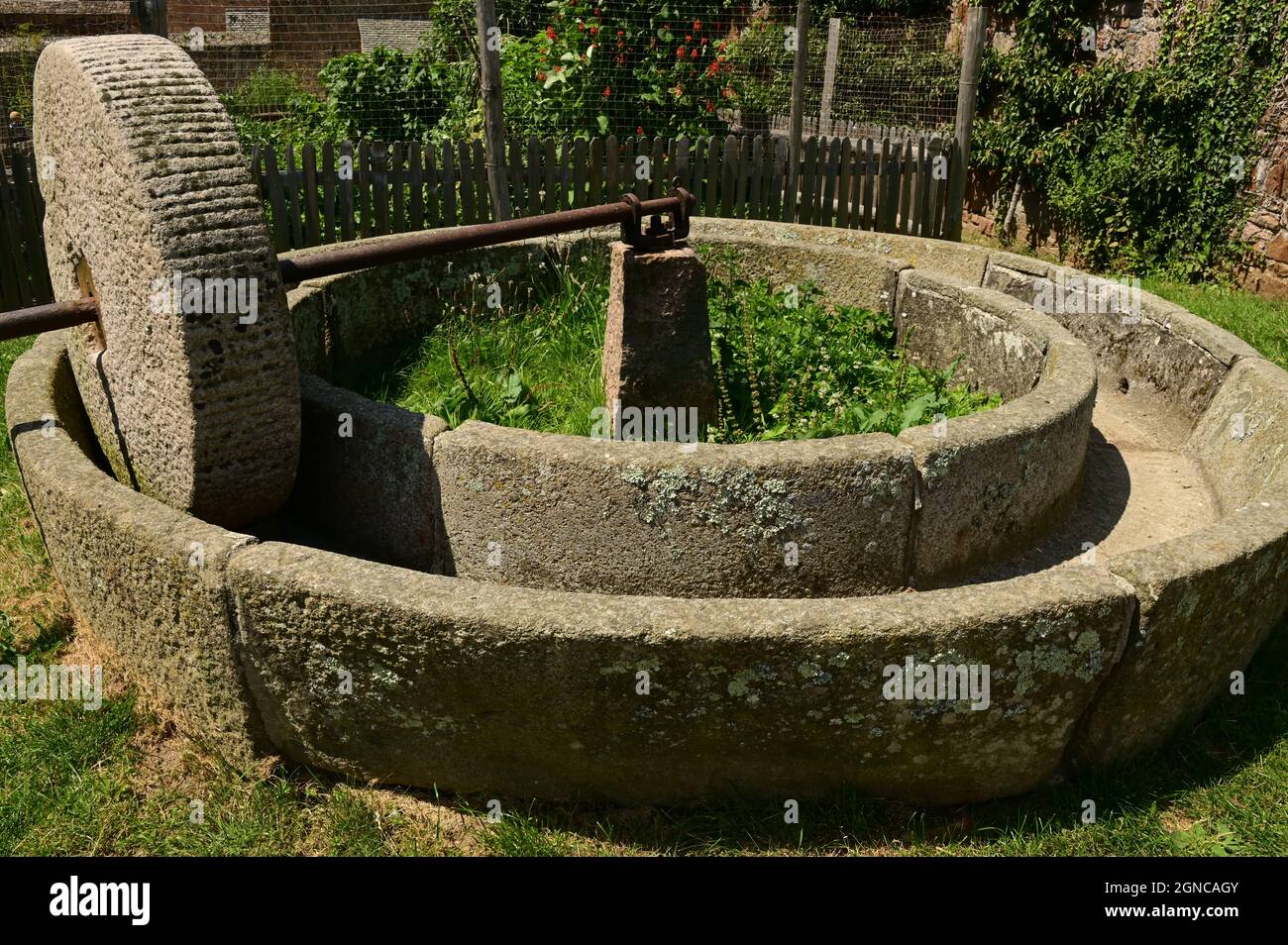 A view of a millstone and wheel in the grounds of a traditional ...