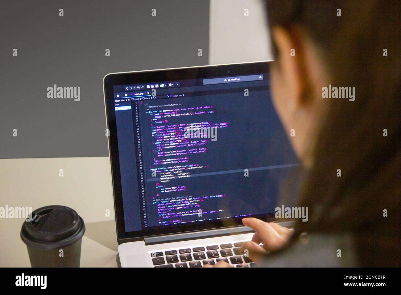 A programmer coding on a laptop in the workplace Stock Photo - Alamy