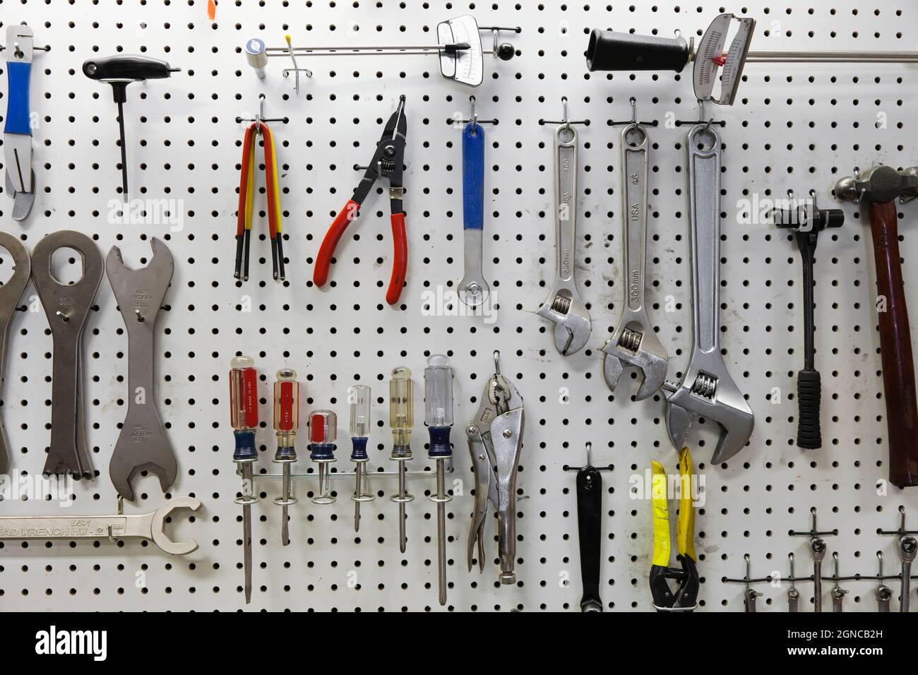 Cycle repair shop interior, tool boards and tools at a service counter ...
