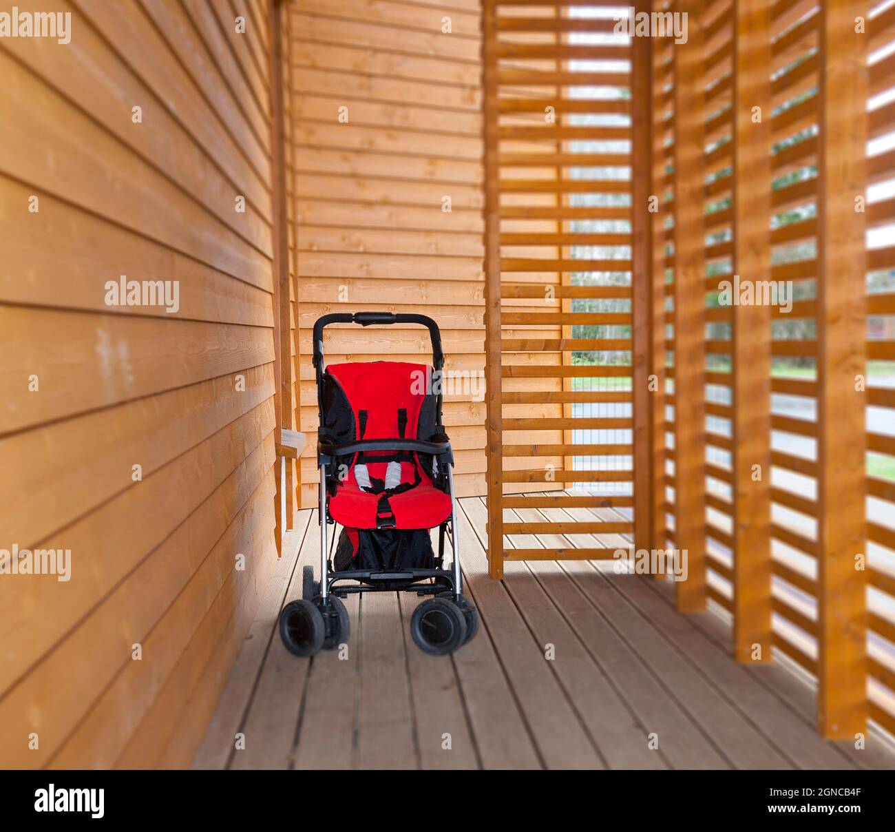 Red child's buggy at the buggy bay at a pre-school or children's day ...