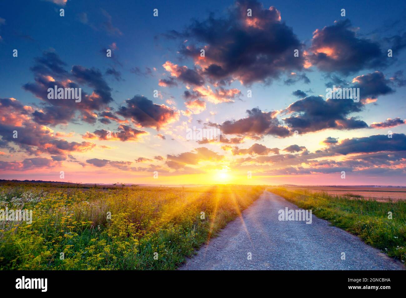 Dramatic summer sunrise in the countryside with old road. Picturesque ...