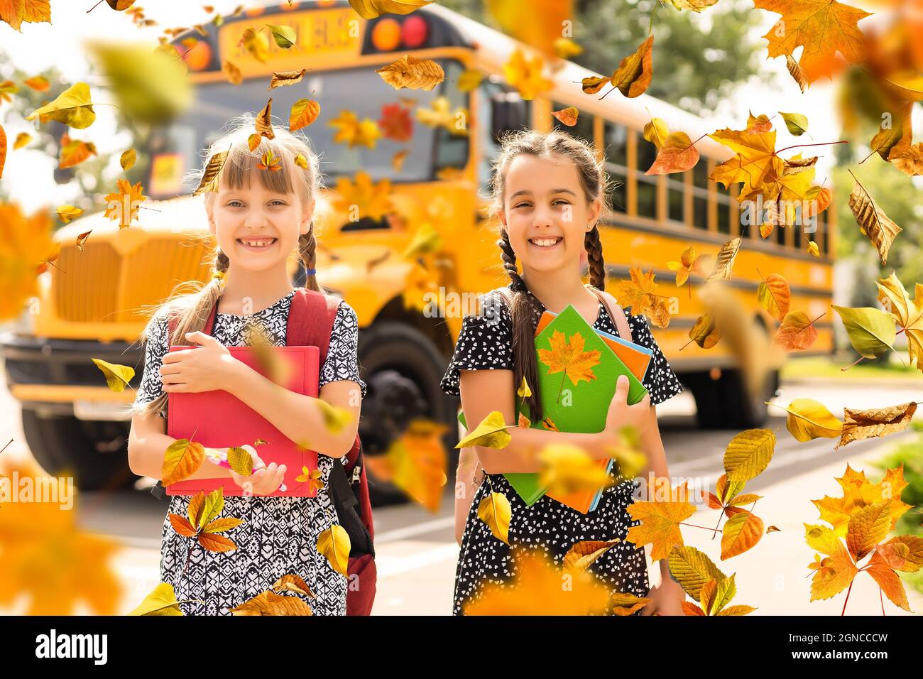 Happy Caucasian children elementary student running by yellow bus on ...