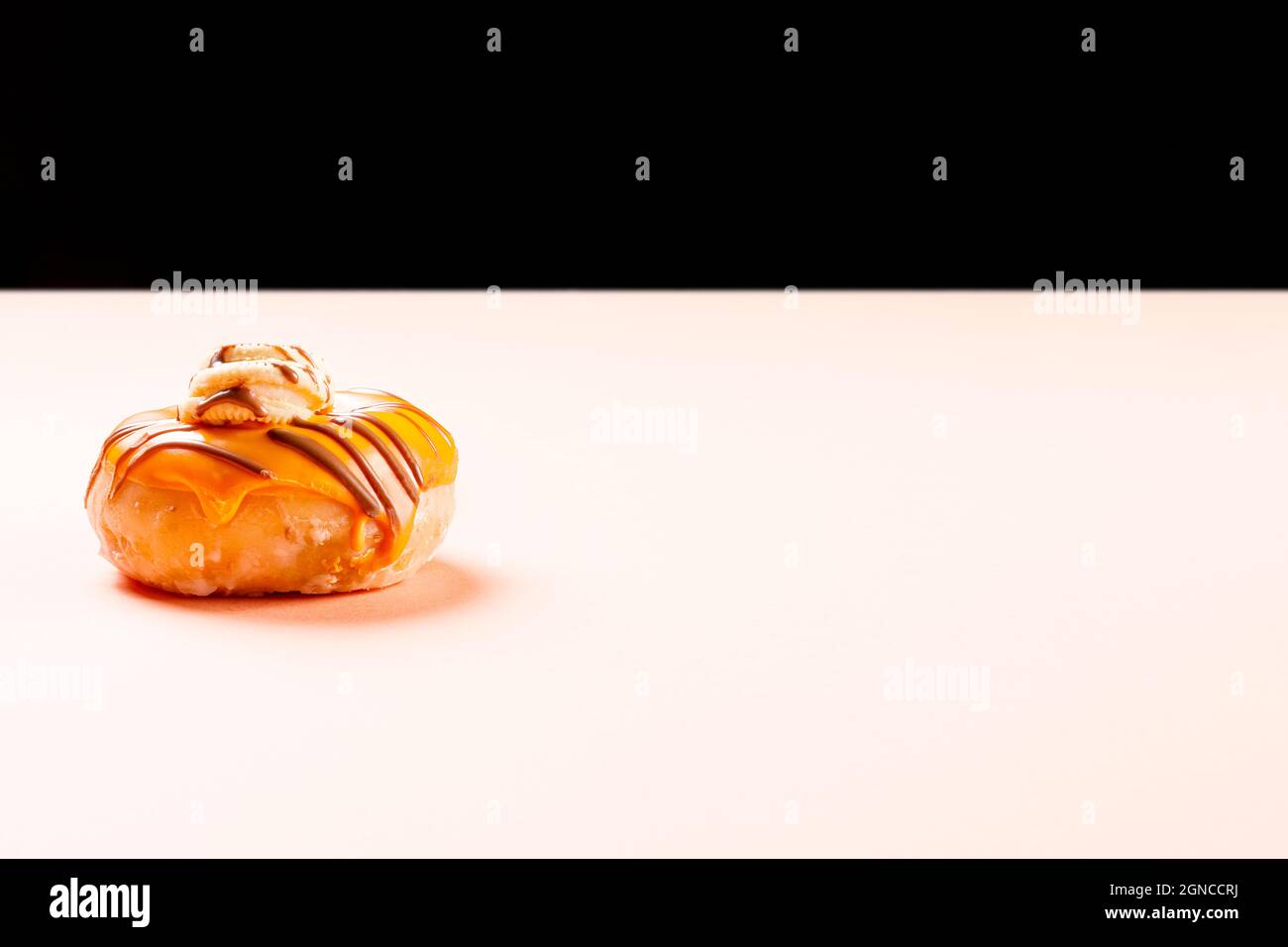 Horizontal photograph of a cream donuts on a light brown cardboard and ...