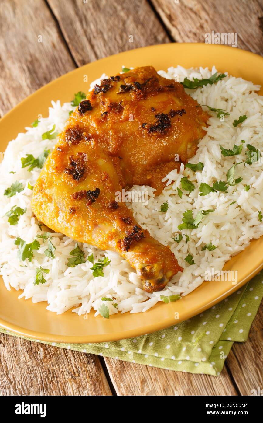 Malaysian Roasted Spiced Chicken Ayam Percik with rice close up in the ...