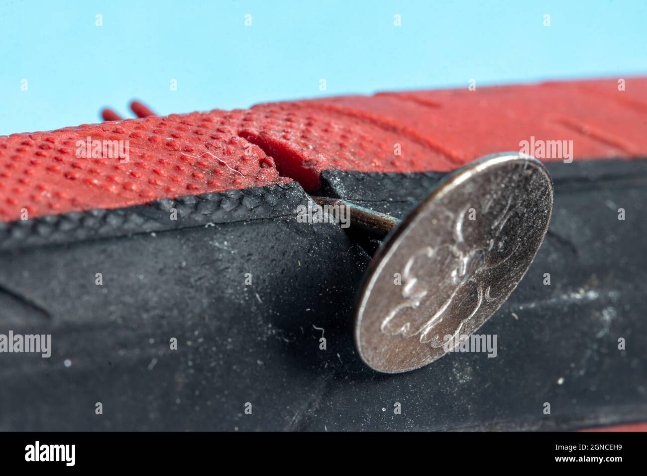 The bicycle tire is damaged by a tack, close up view Stock Photo - Alamy