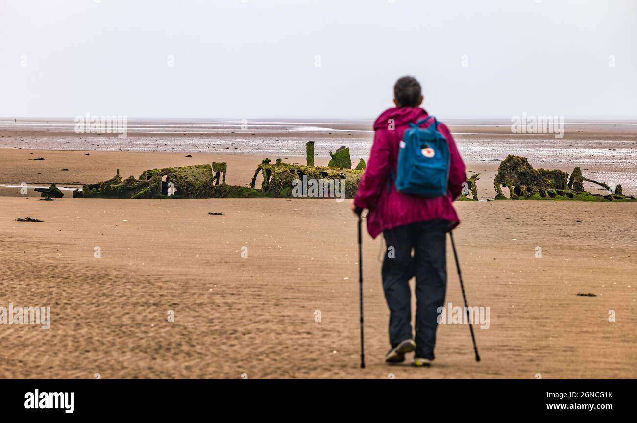 Older walker looking at World War II XT class midget submarine buried ...