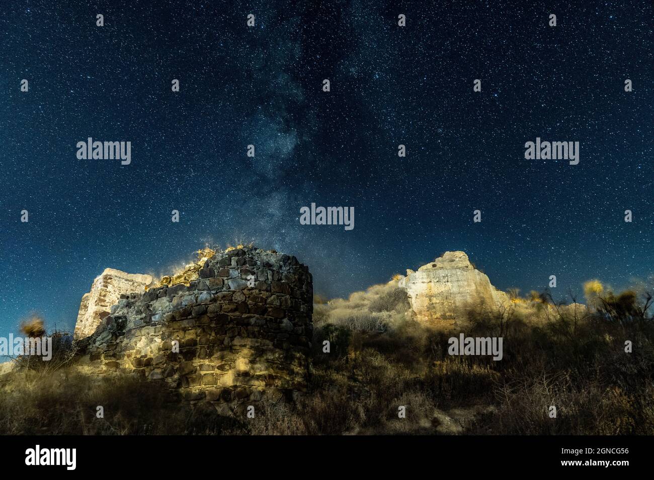 Beautiful view of a hill with plants and ruins of fortresses under a ...