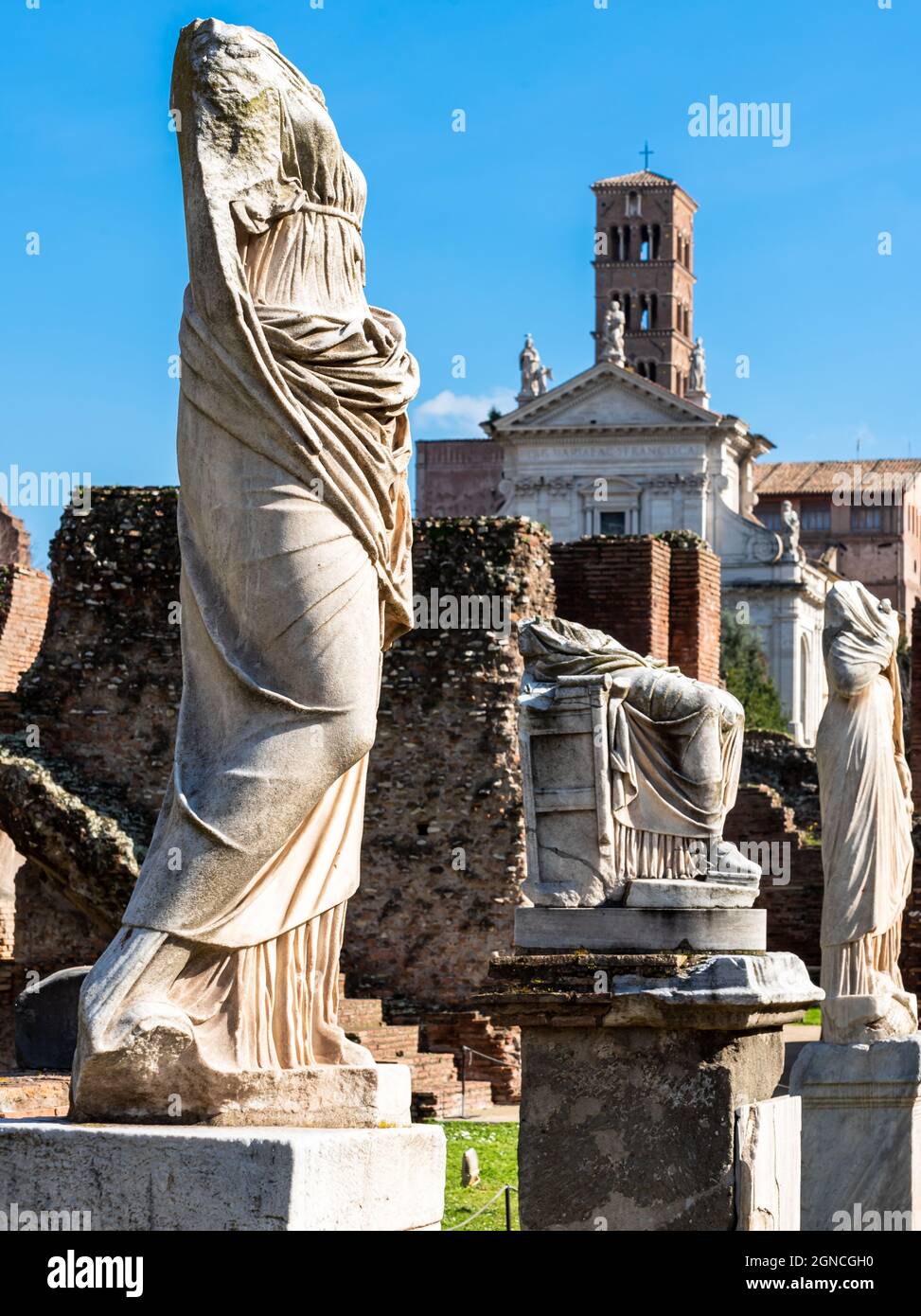 Ancient marble statues in ruins decorating the exterior patio of a ...