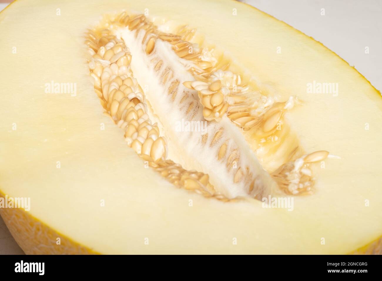 yellow ripe melon cut in half close-up, seasonal berry Stock Photo - Alamy