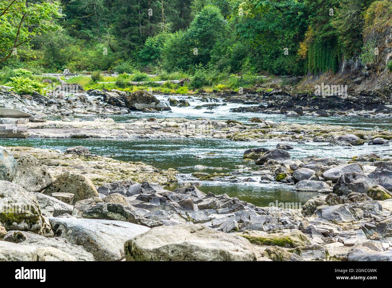 Rocks line the shore along the Snoqualmie River in Washington State ...