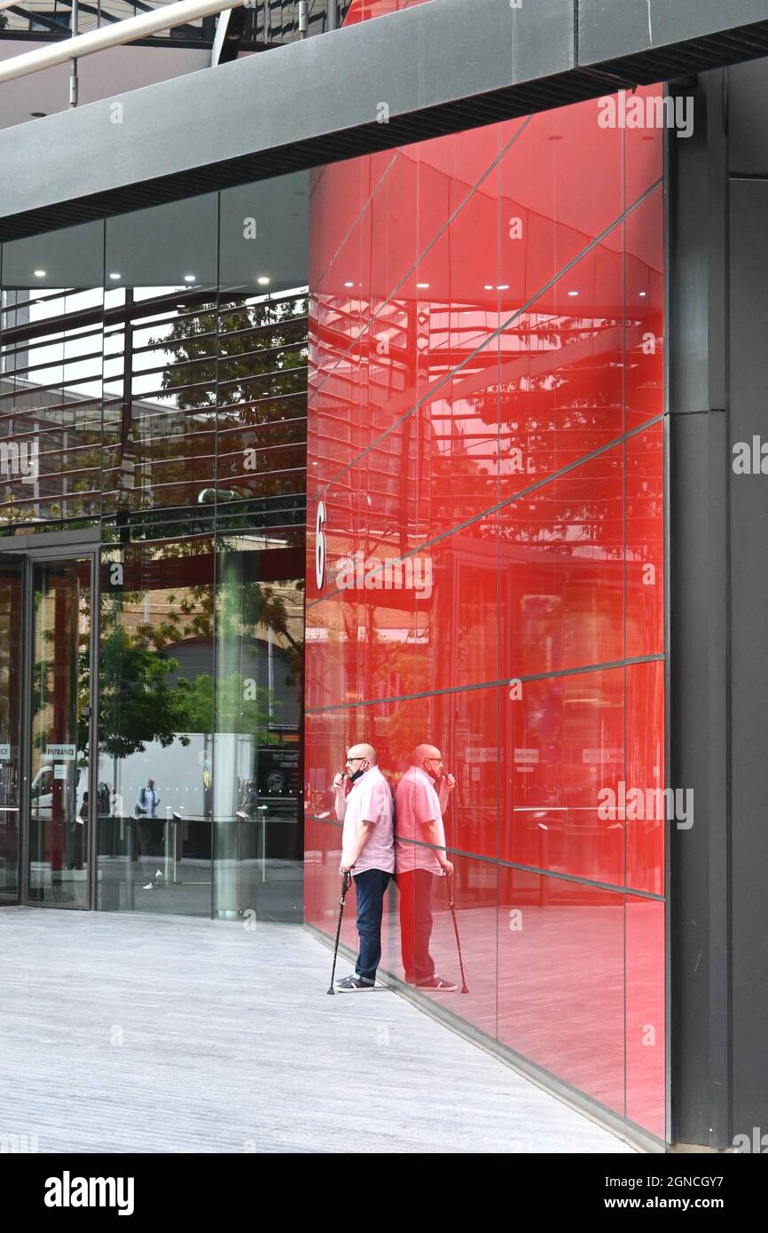 Man smoking outside building in More London Stock Photo - Alamy