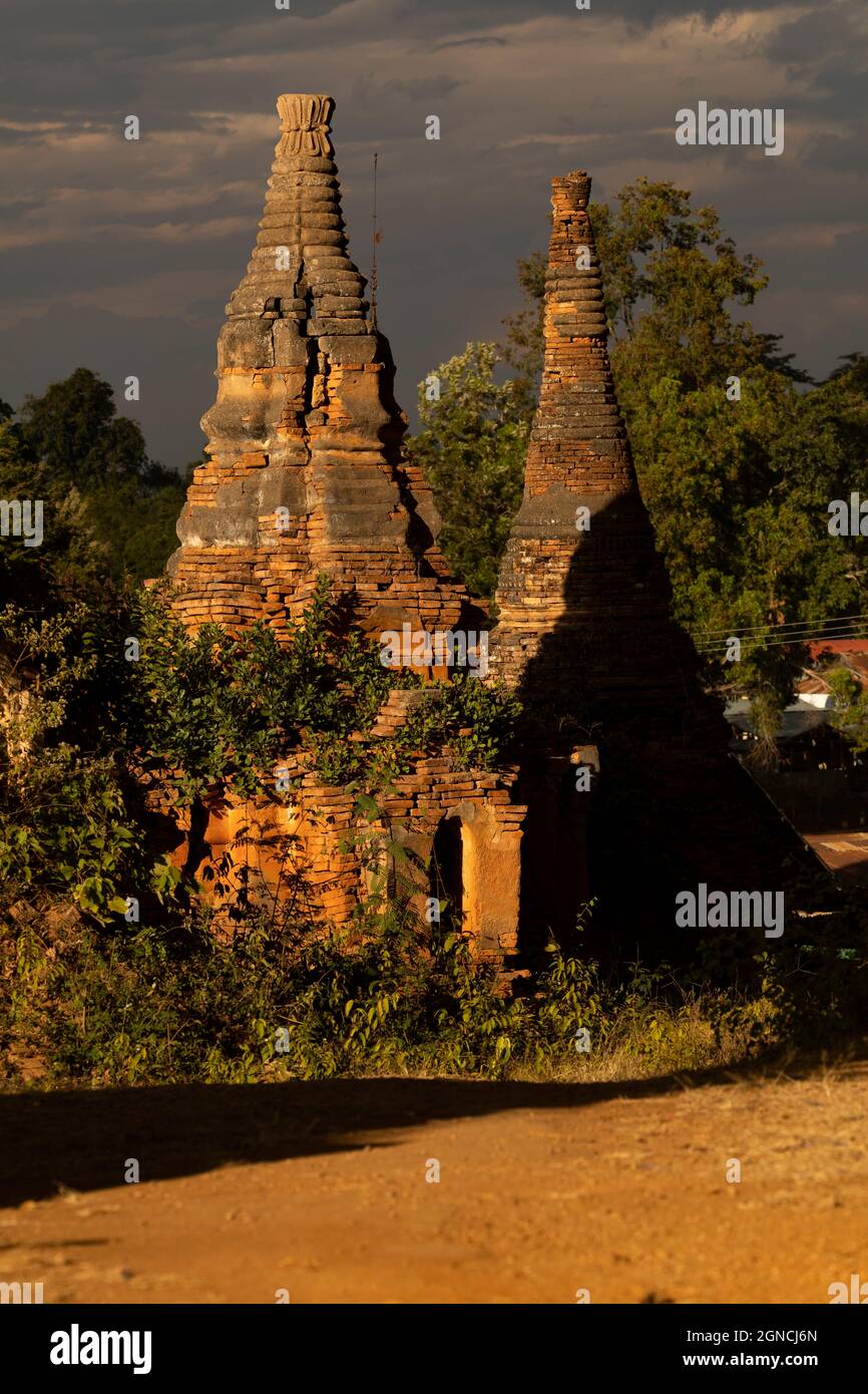 Ancient pagodas and stupas overrun with plants, almost in ruins, in ...