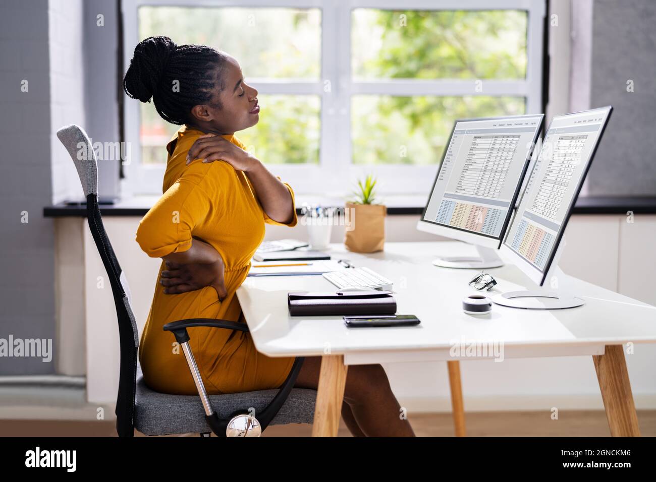 Back Pain Bad Posture Woman Sitting In Office Stock Photo - Alamy