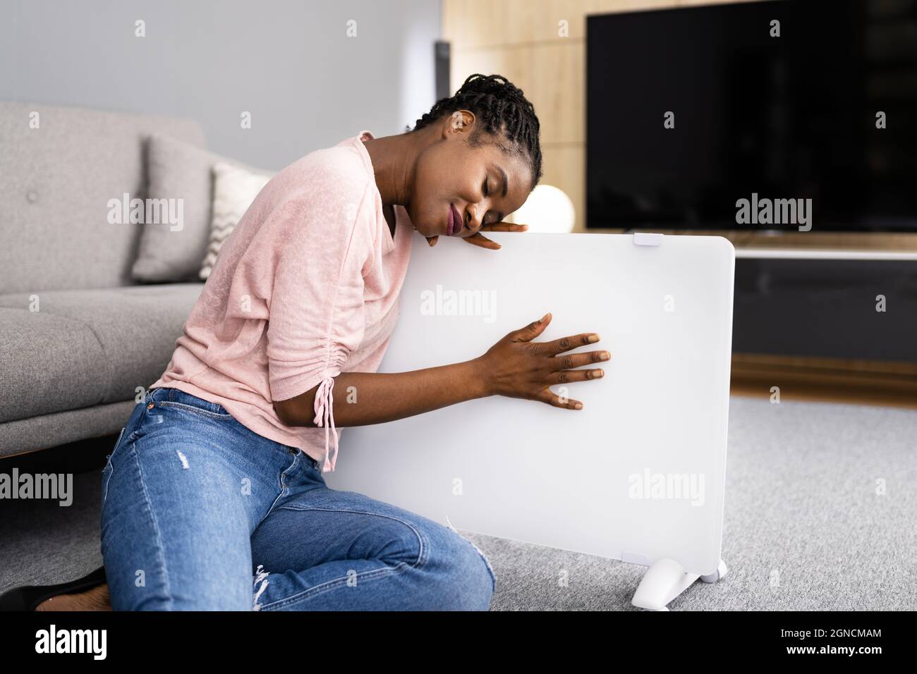 Happy Warm Woman Near Radiator With Heat Comfort Stock Photo - Alamy