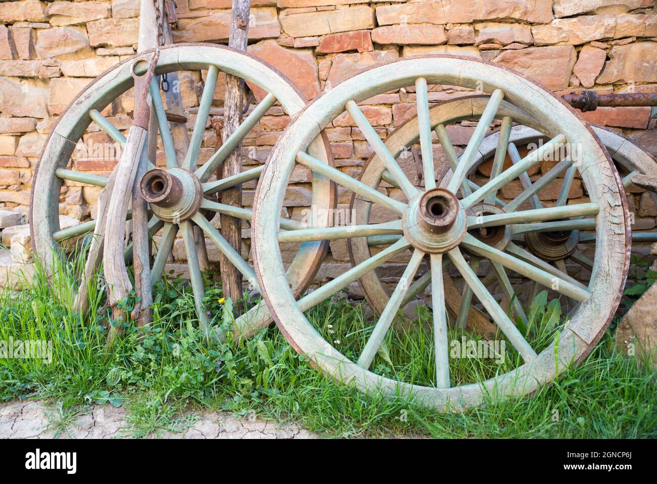 Closeup of vintage cartwheels in the yard of a rural house Stock Photo ...