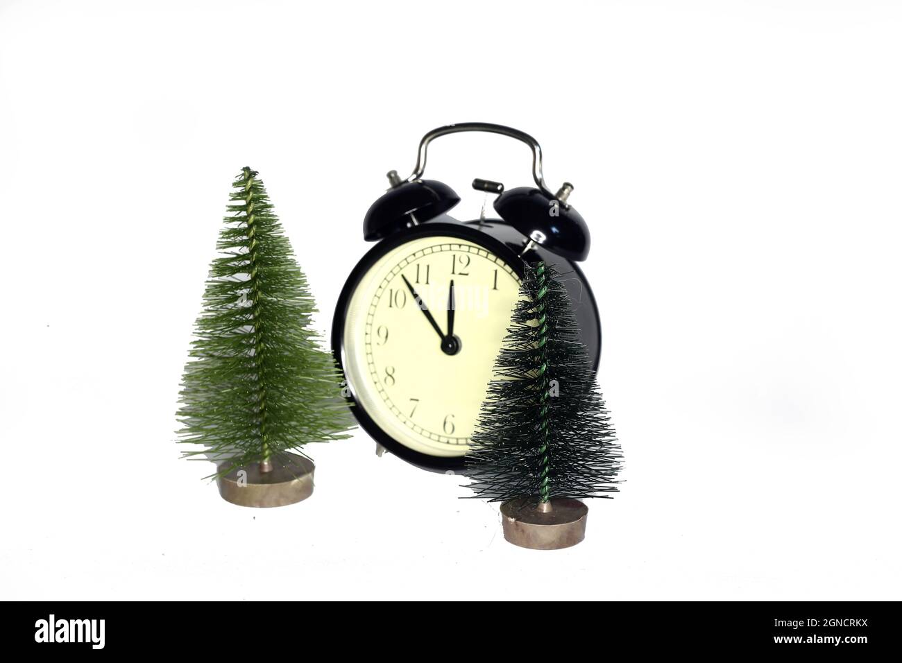 new year concept - alarm clock and fir trees isolated on white ...