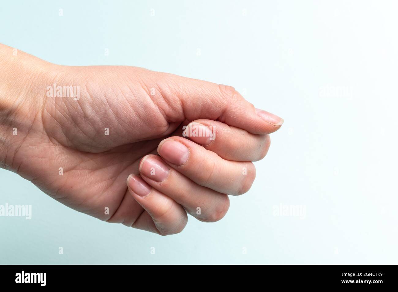Close-up of a Caucasian female hand with natural unpolished nails ...