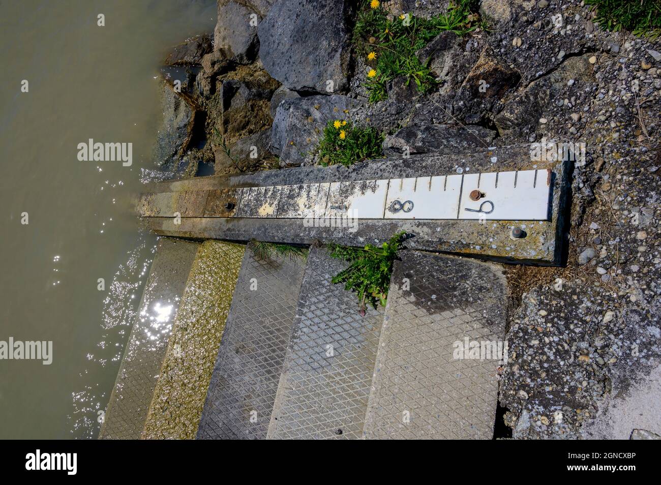 staircase with water-level indicator at the embankment of the river ...