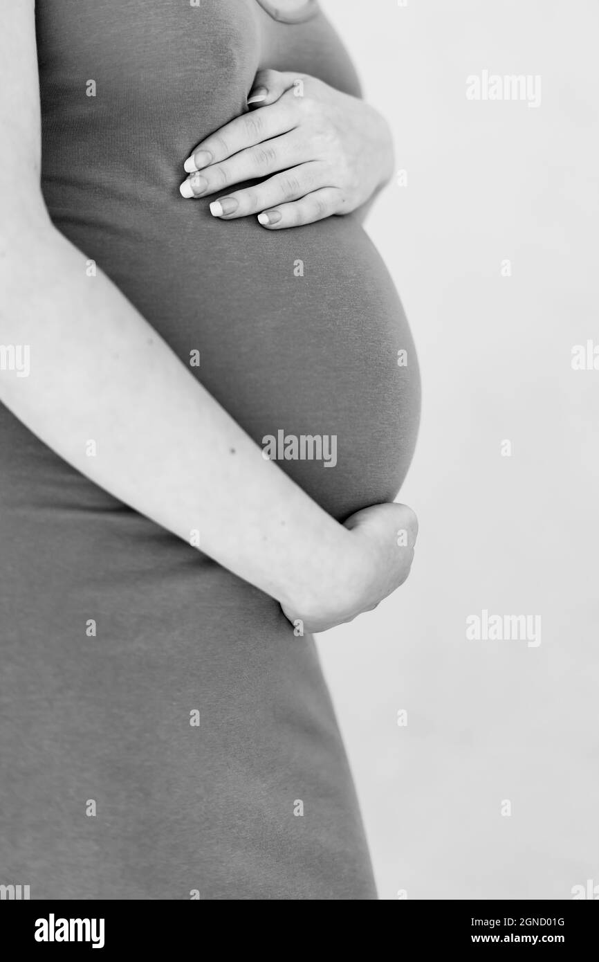 Pregnant woman holding her belly. 27 weeks Stock Photo - Alamy