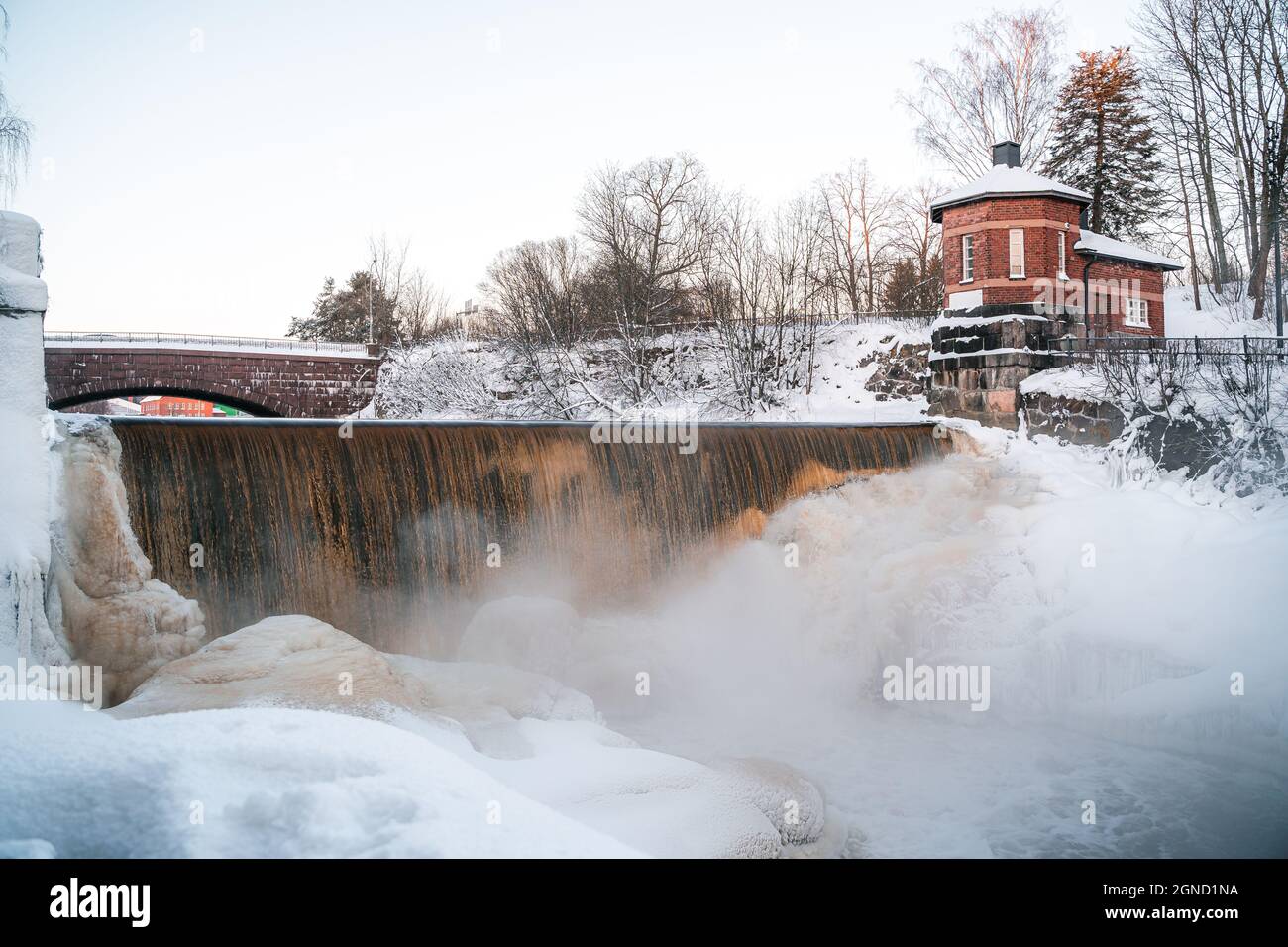 Steaming water going into a snowy dam during winter Stock Photo - Alamy
