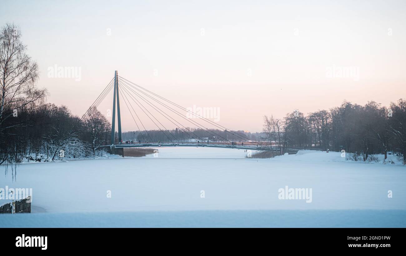 Cable bridge over frozen water Stock Photo - Alamy