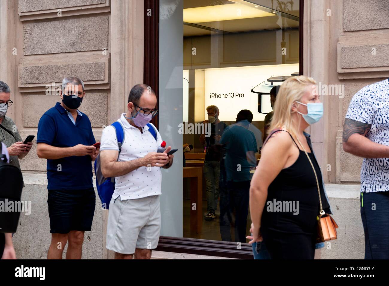 People in a queue at the Apple store during the first day of sale of ...