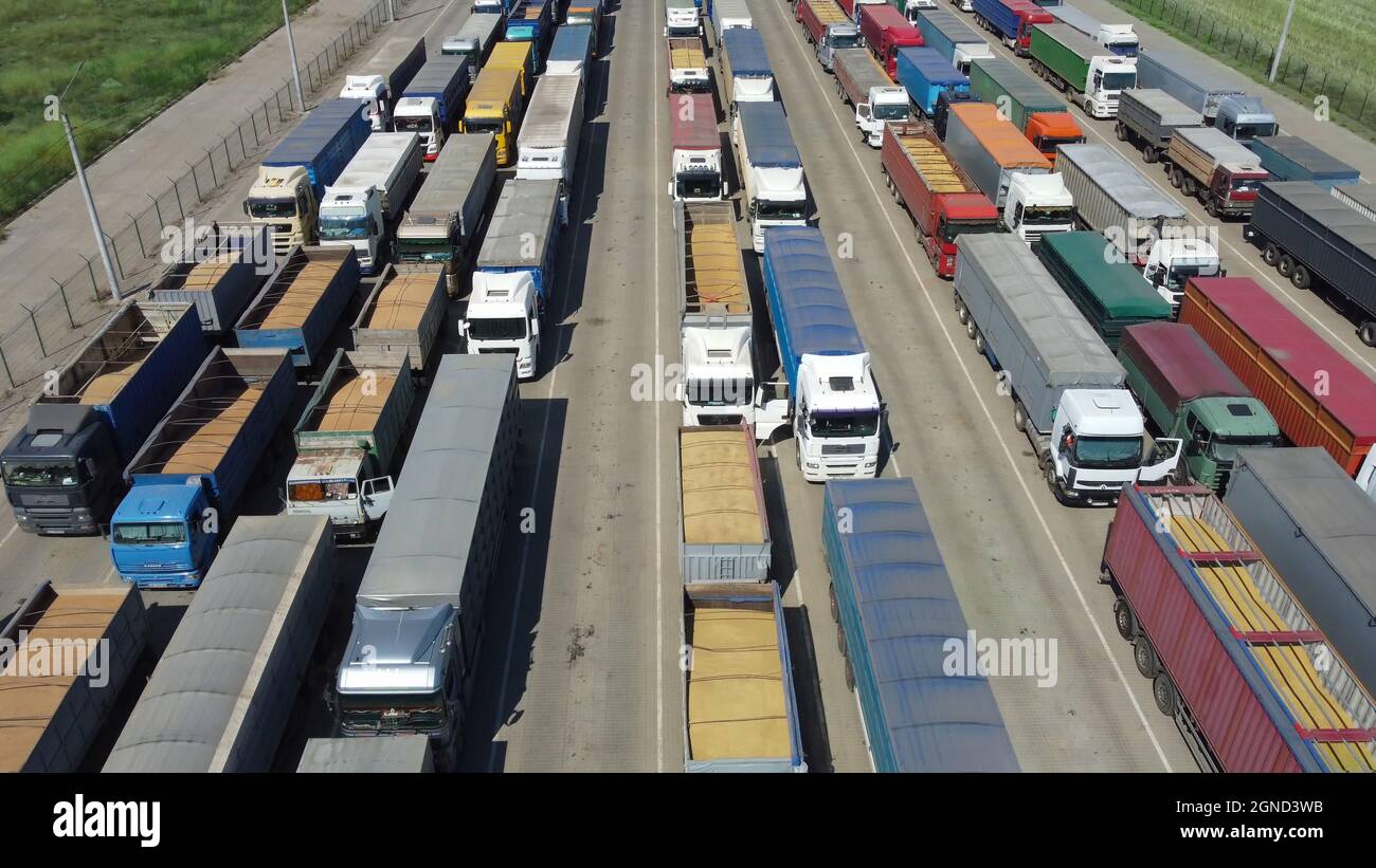 Various trucks stand in the parking lot waiting for unloading ...
