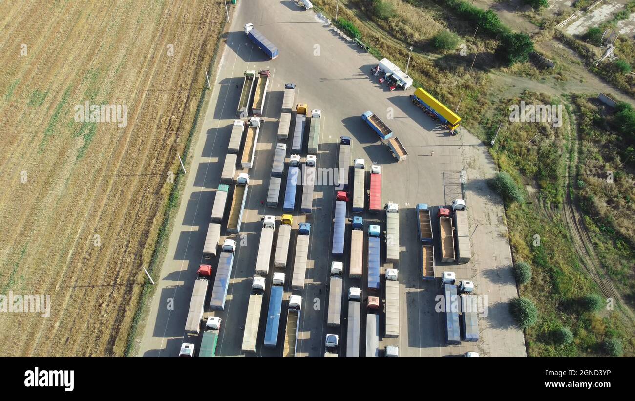 Trucks stand in line for unloading. Terminal in the port with loaded ...